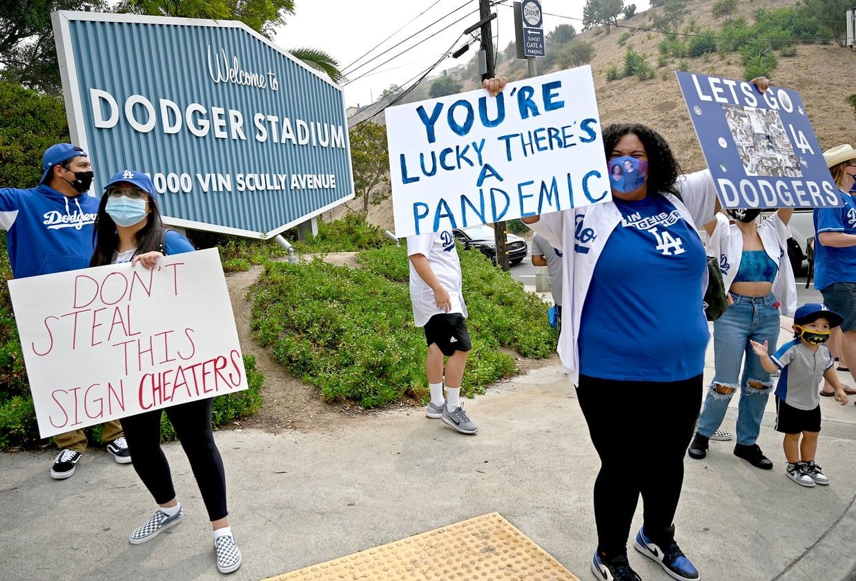 LOOK: Dodgers fans heckle Houston Astros' bus, troll team with signs ...